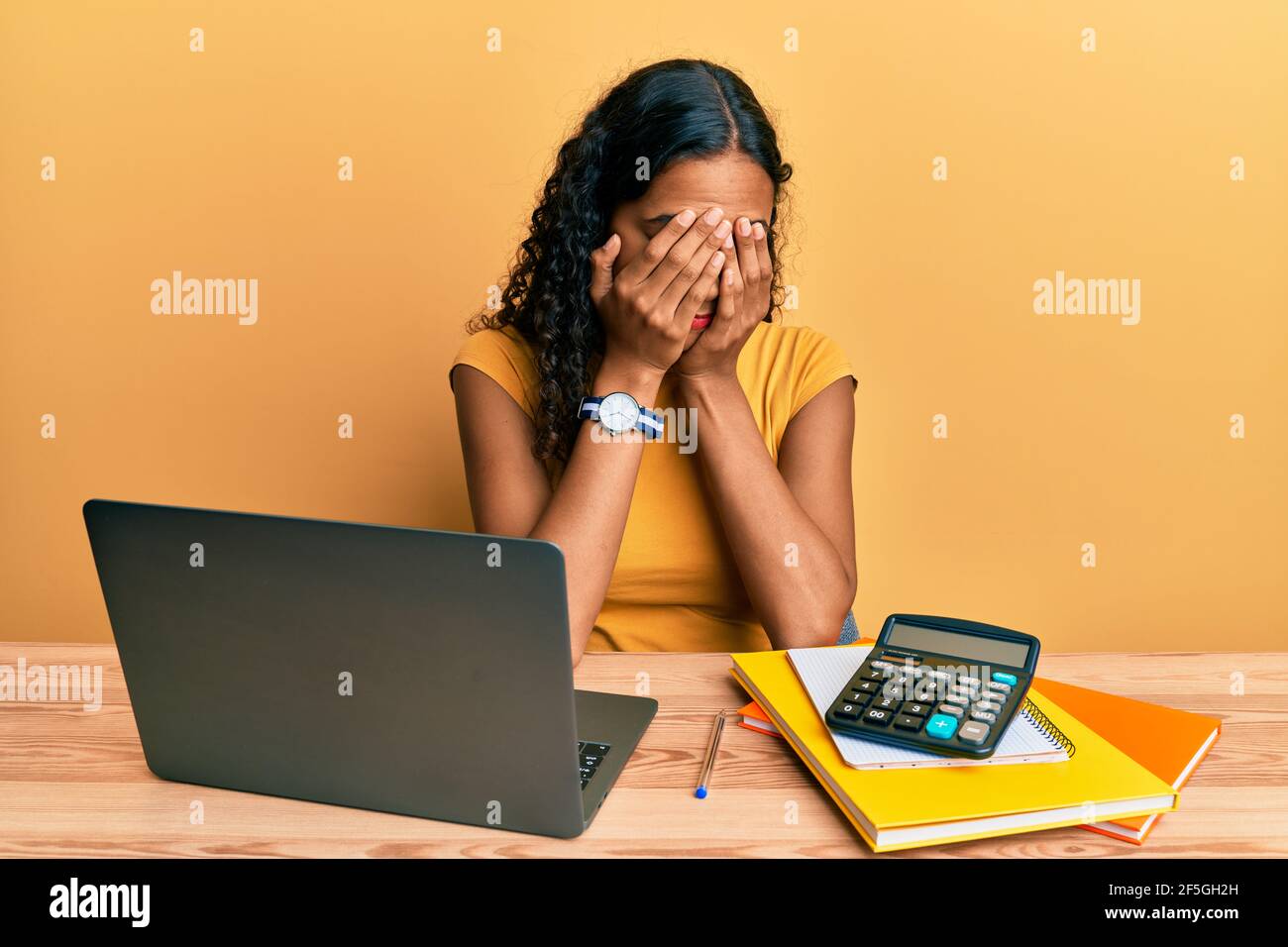 Young african american girl working at the office with laptop and ...
