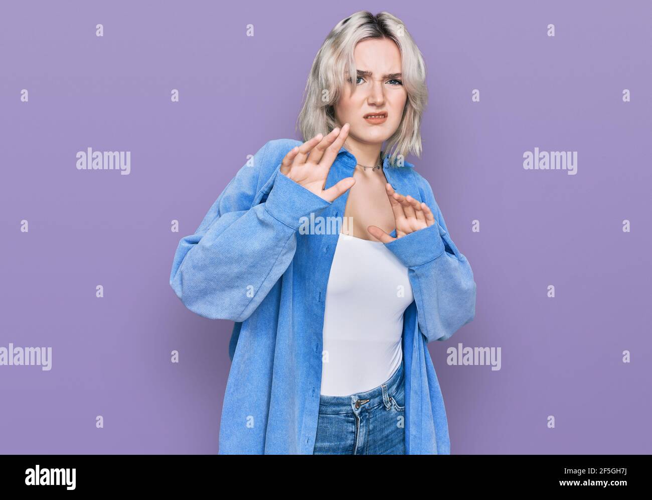 Young blonde girl wearing casual clothes disgusted expression ...