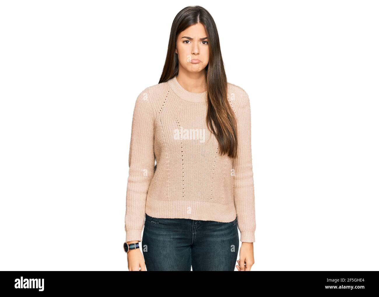 Young brunette woman wearing casual winter sweater depressed and worry ...