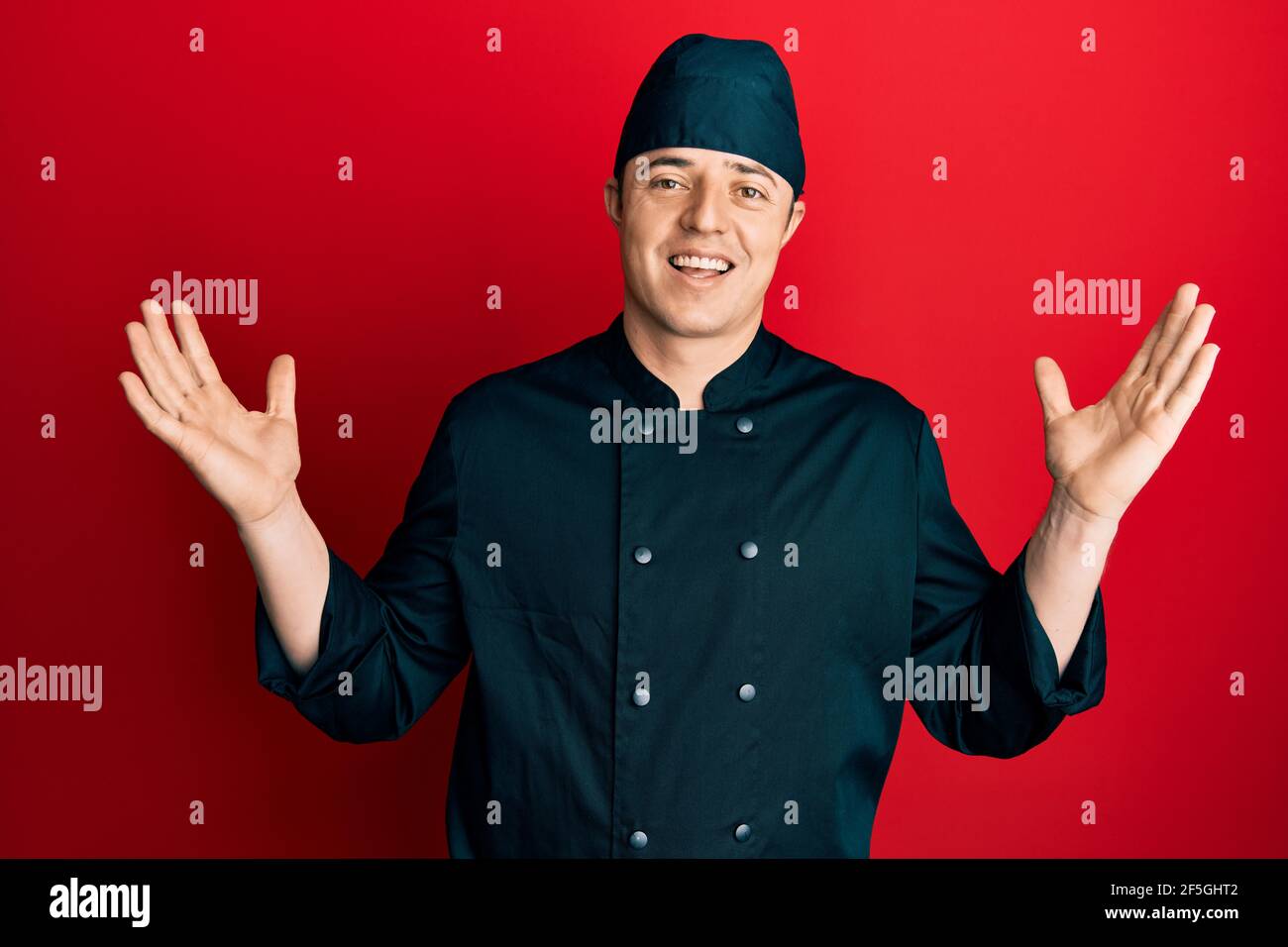 Handsome young man wearing professional cook uniform and hat ...