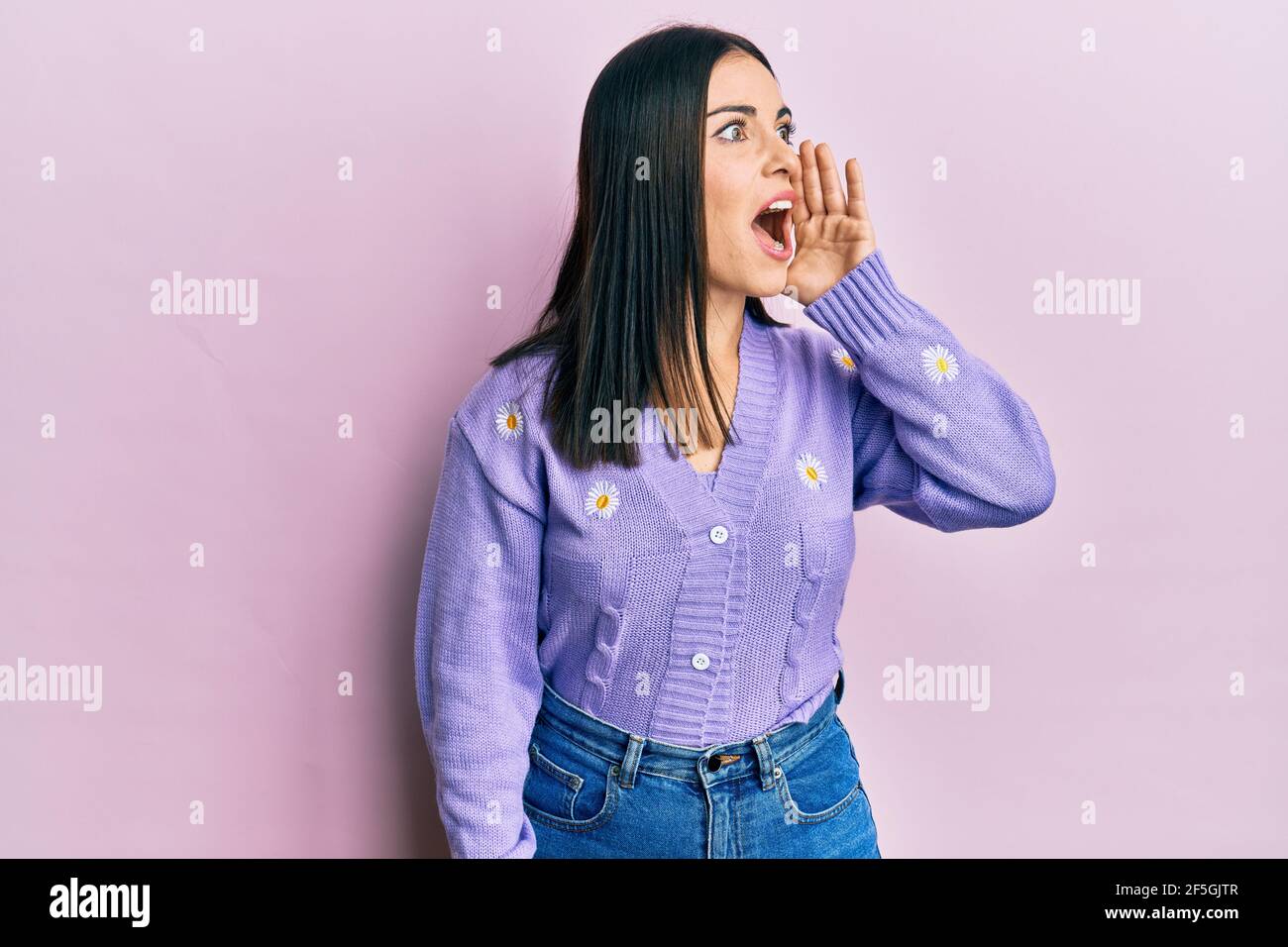 Young brunette woman wearing spring cardigan with flowers print ...