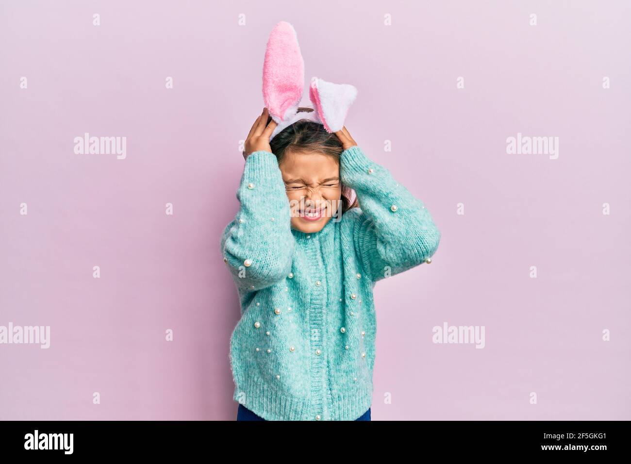 Little beautiful girl wearing cute easter bunny ears suffering from ...