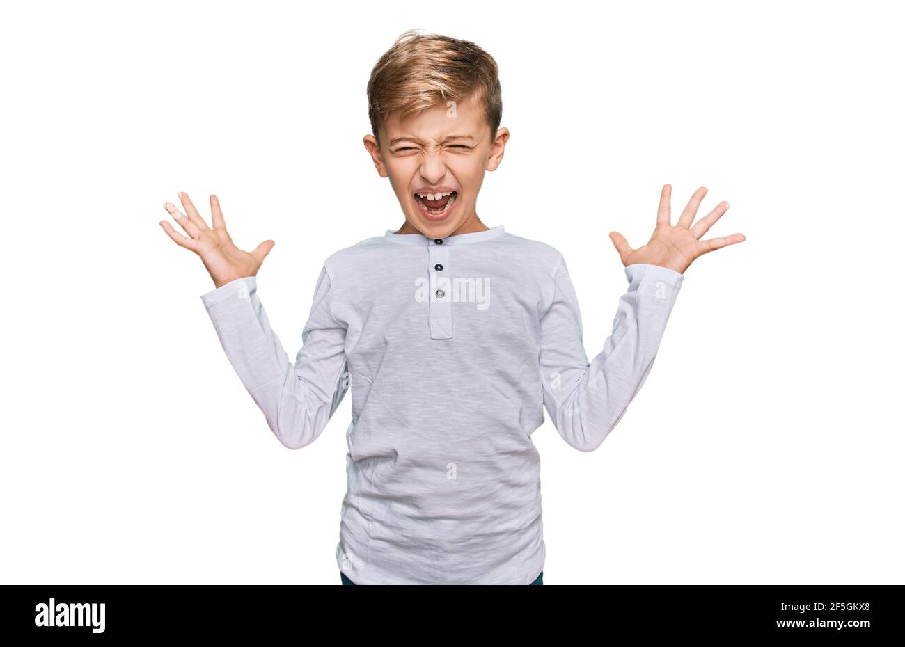 Little caucasian boy kid wearing casual clothes celebrating mad and ...