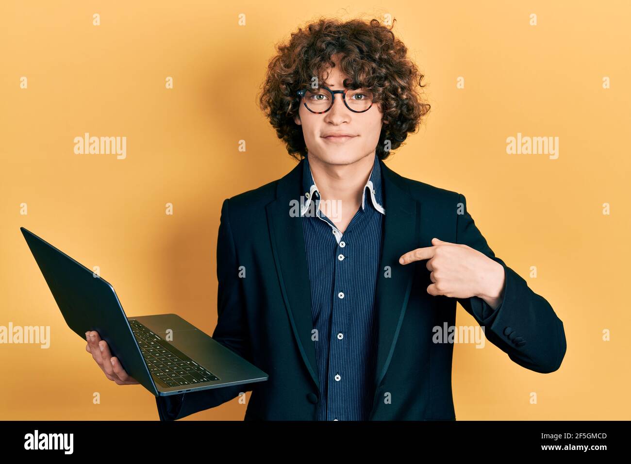 Handsome young man working using computer laptop pointing finger to one ...