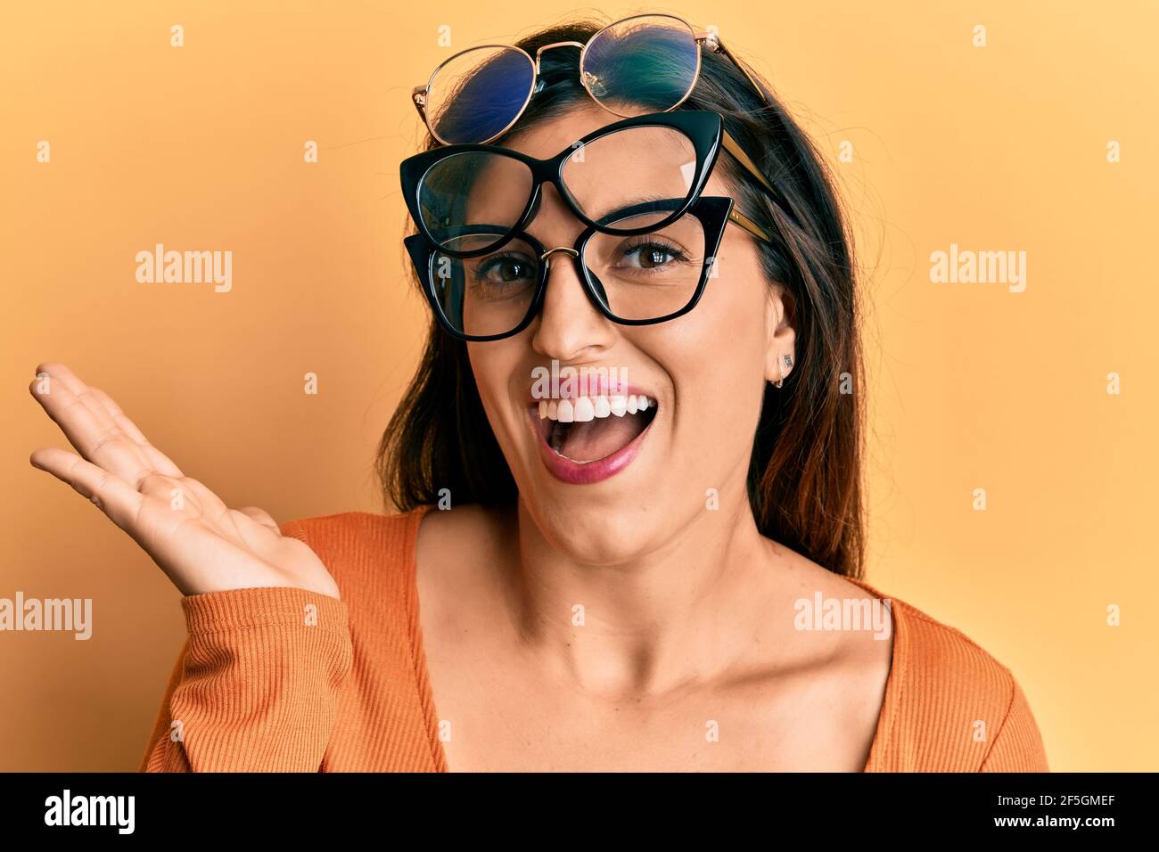 Beautiful hispanic woman wearing many glass over face celebrating ...