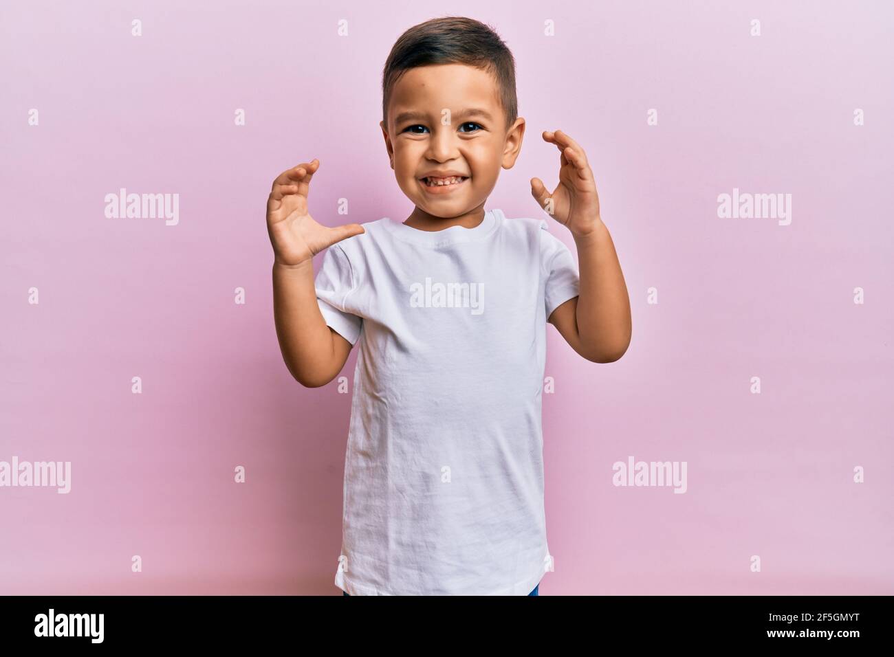 Adorable latin toddler holding ice cream looking positive and happy ...
