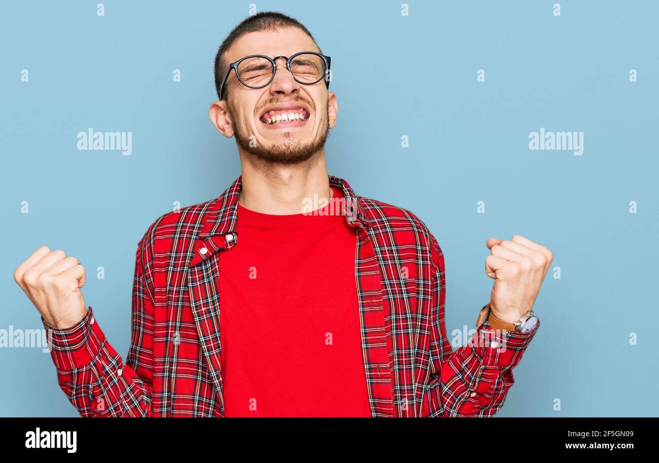 Hispanic young man wearing casual clothes very happy and excited doing ...