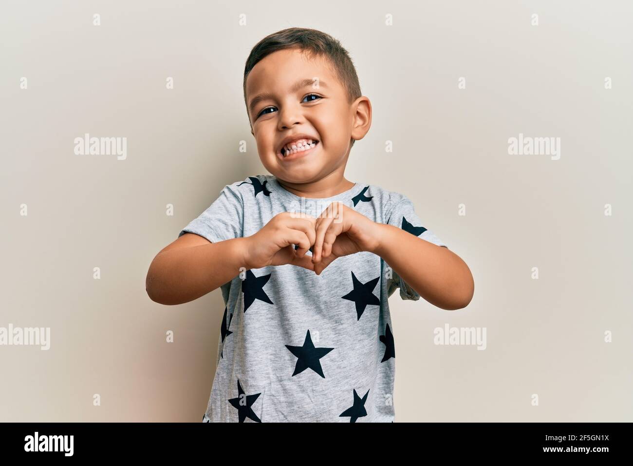 Adorable latin toddler wearing casual clothes smiling in love doing ...