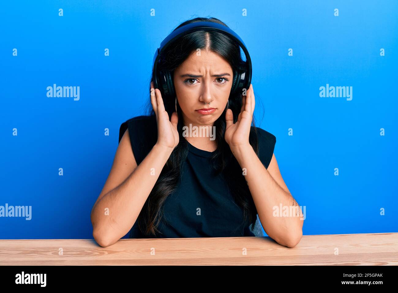 Beautiful brunette young woman listening to music using headphones ...