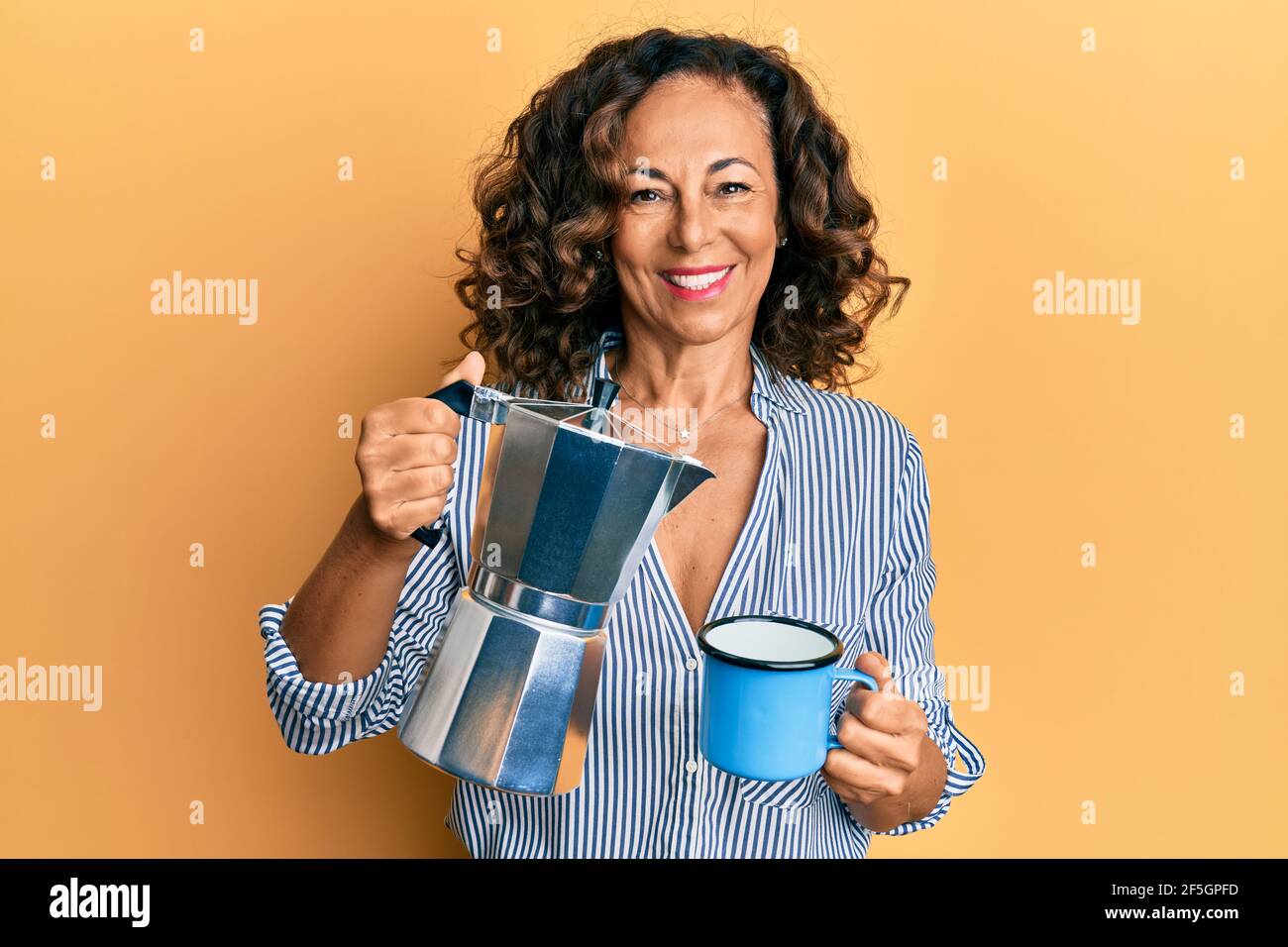 Middle age hispanic woman drinking italian coffee smiling with a happy ...