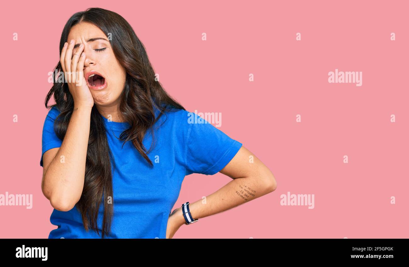 Beautiful brunette young woman wearing casual clothes yawning tired ...
