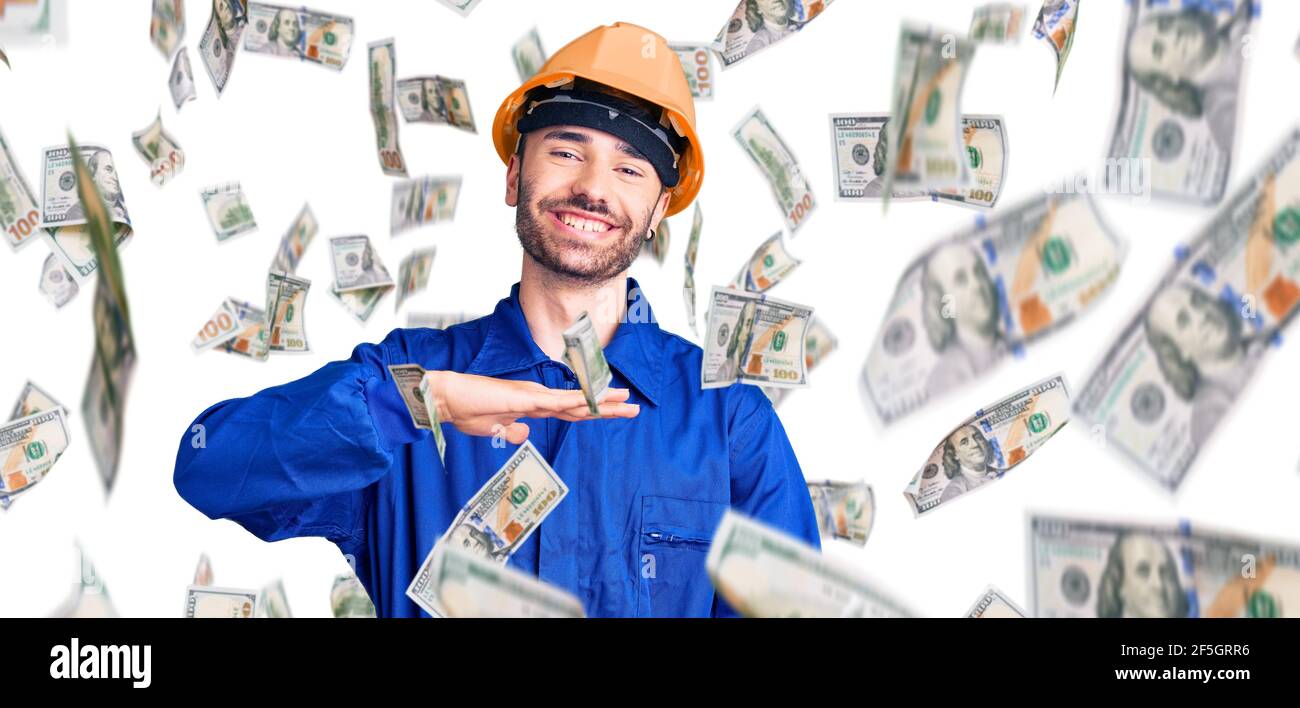 Young hispanic man wearing worker uniform gesturing with hands showing ...