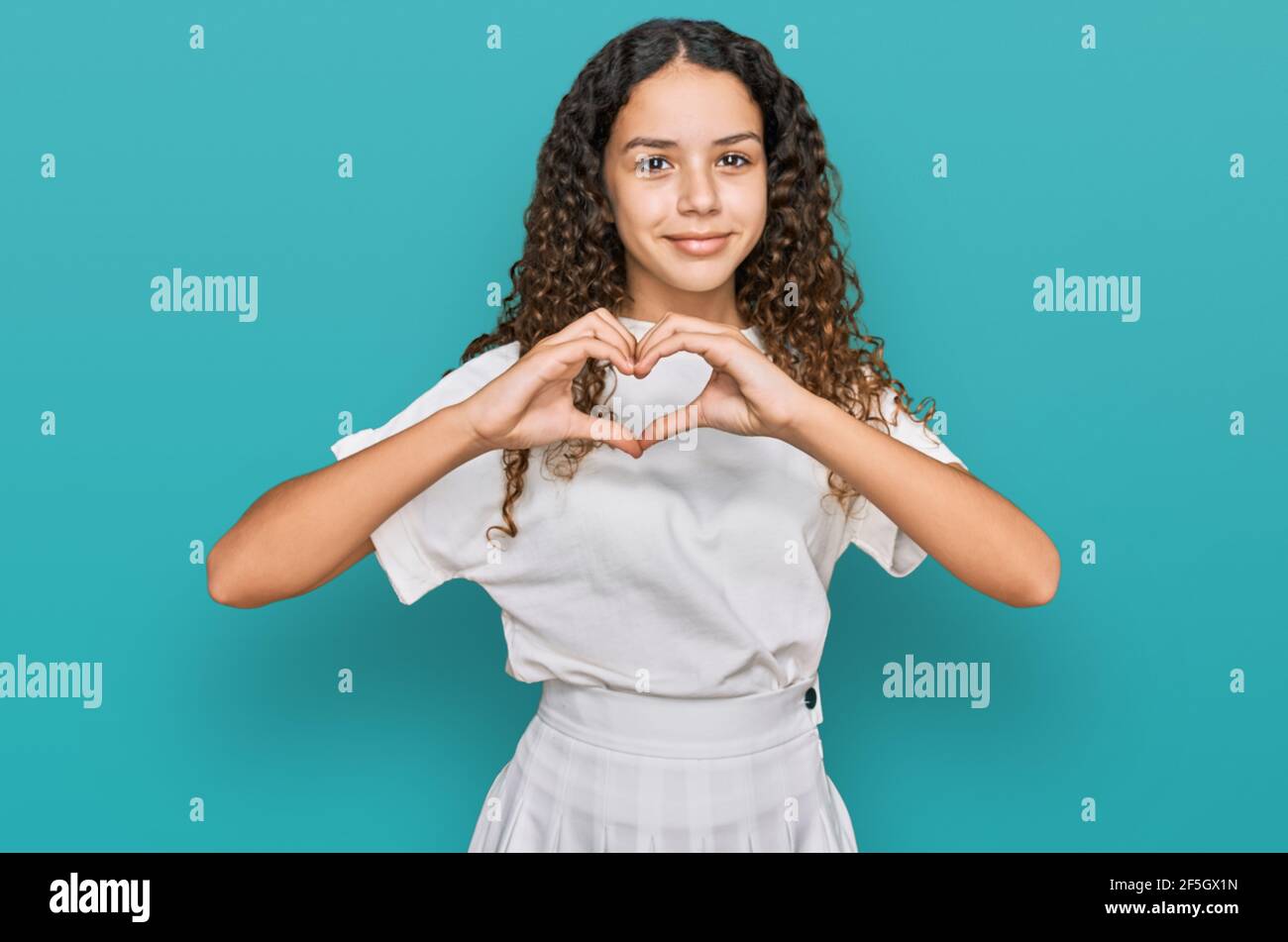 Teenager Hispanic Girl Wearing Casual White T Shirt Smiling In Love