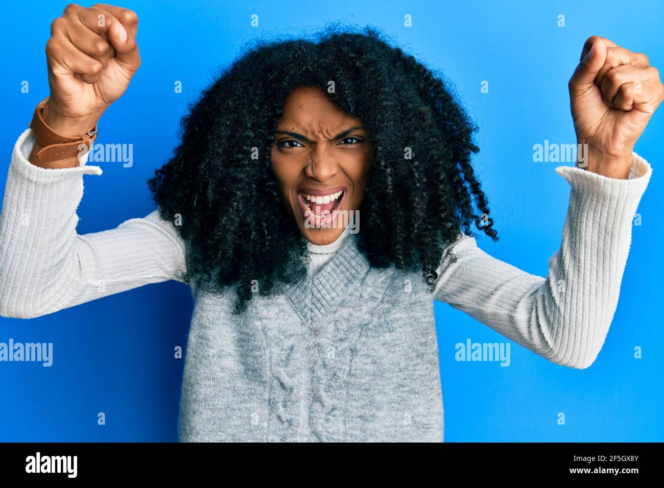 African american woman with afro hair wearing casual winter sweater ...