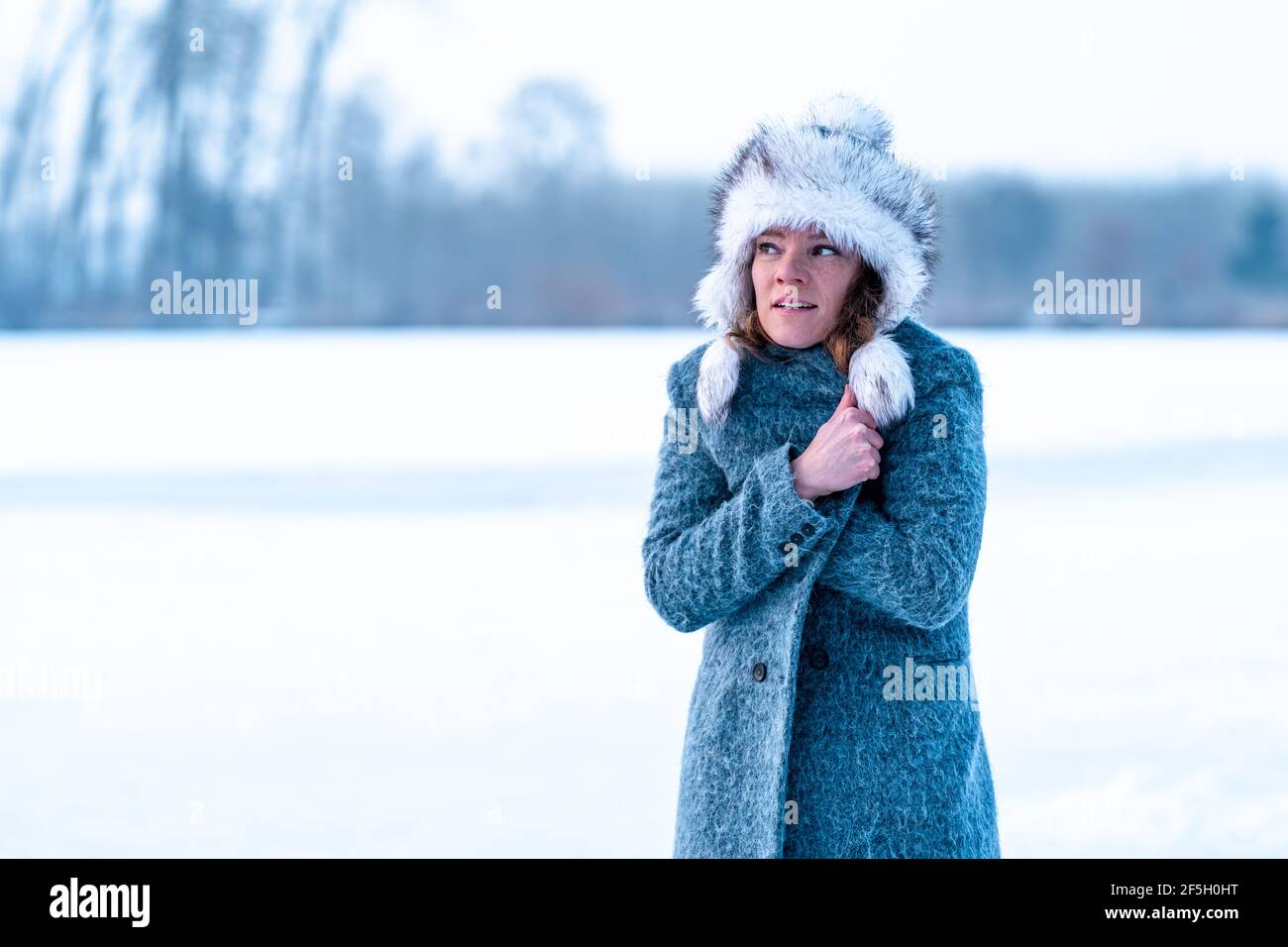 young freezing woman on winter icy lake. Banner. Copy space Stock Photo ...