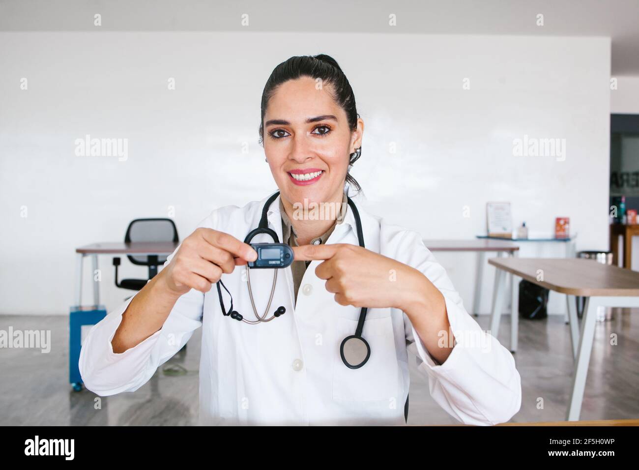 Portrait Of latin Female Doctor Wearing White Coat With Stethoscope In ...