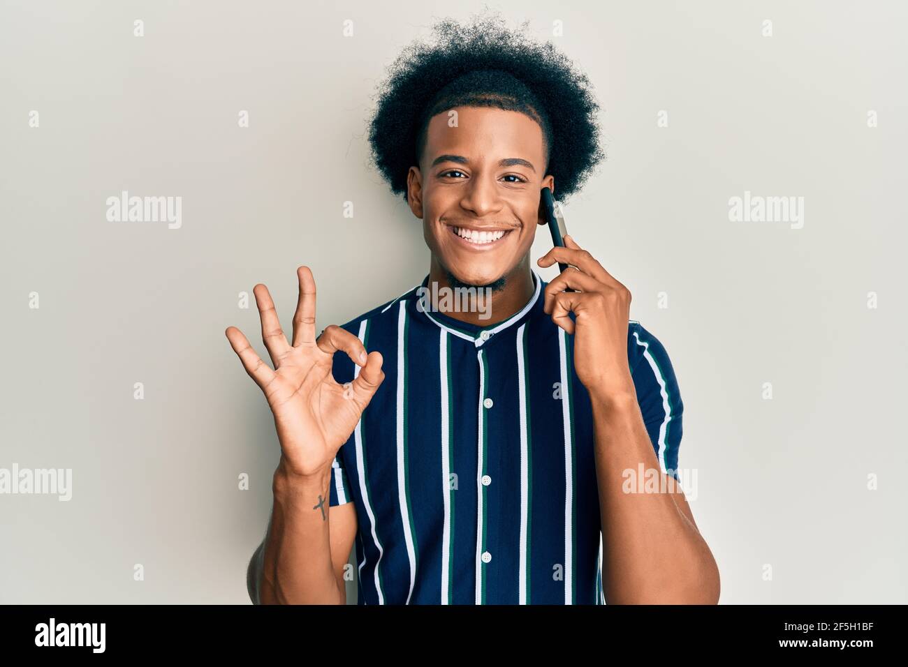 African american man with afro hair having conversation talking on the ...