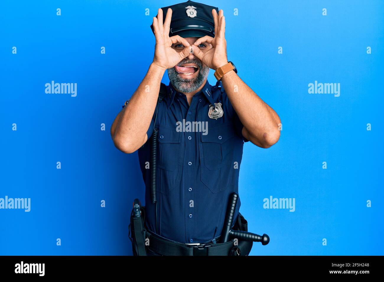 Middle age handsome man wearing police uniform doing ok gesture like ...