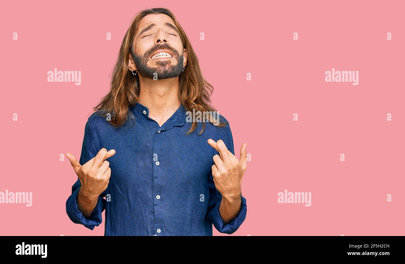 Attractive man with long hair and beard wearing casual clothes ...