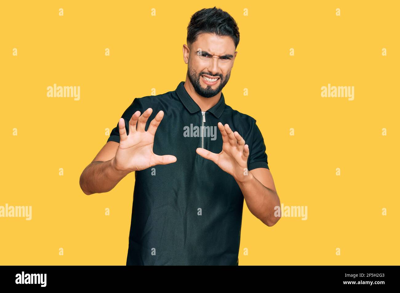Young man with beard wearing sportswear disgusted expression ...