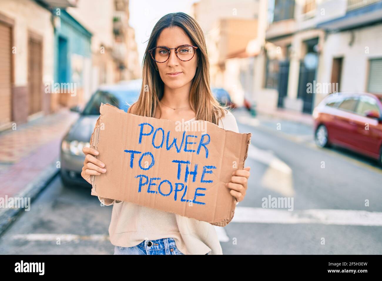 Young caucasian woman with relaxed expression holding power to the ...