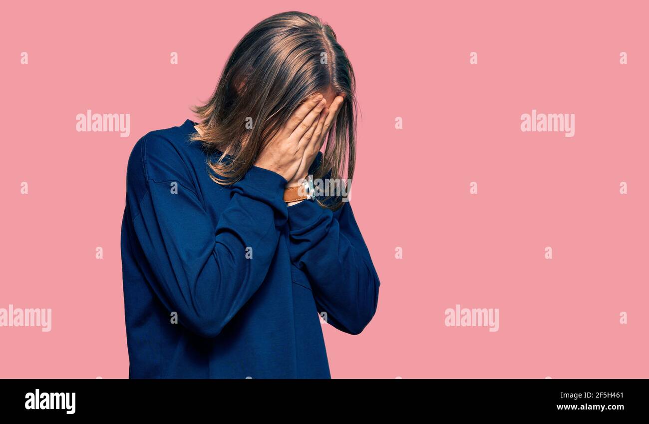 Handsome caucasian man with long hair wearing casual winter sweater ...