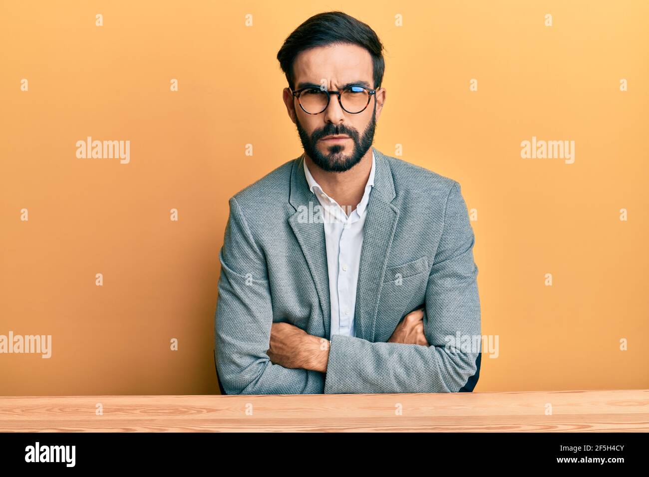 Young hispanic man working at the office skeptic and nervous ...