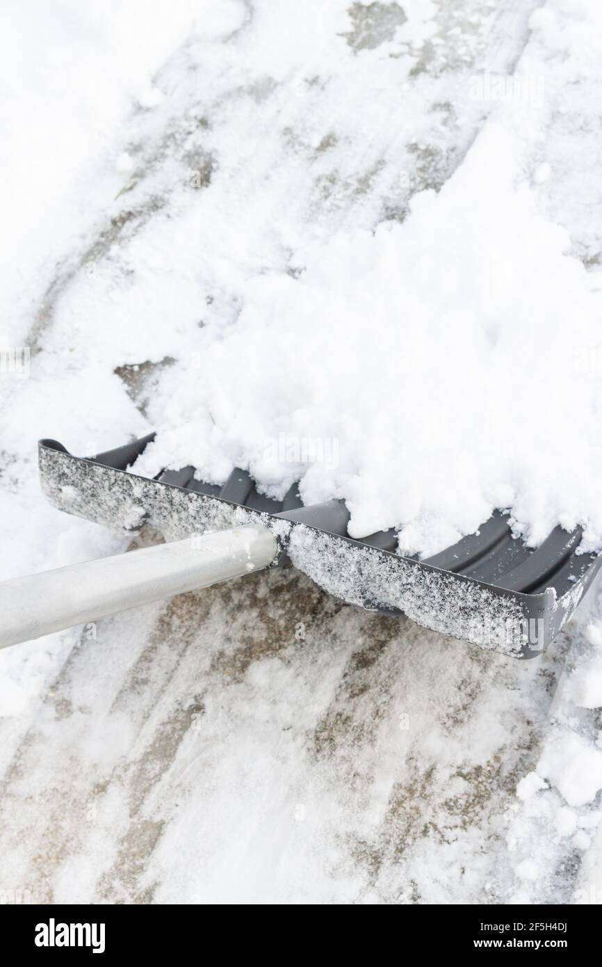Snow cleaning with a large shovel in winter Stock Photo - Alamy