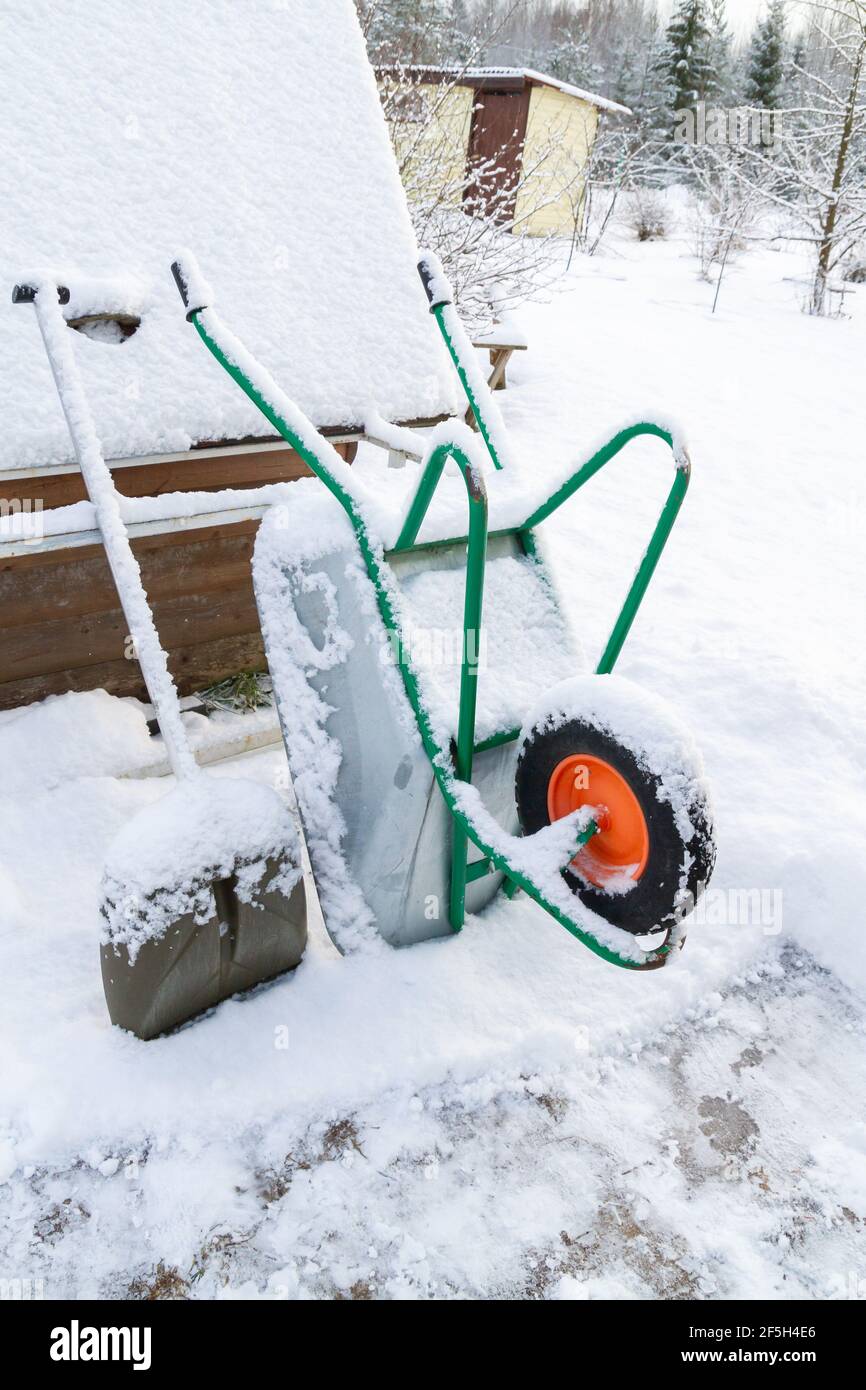 Metal garden wheelbarrow in the snow in winter Stock Photo - Alamy