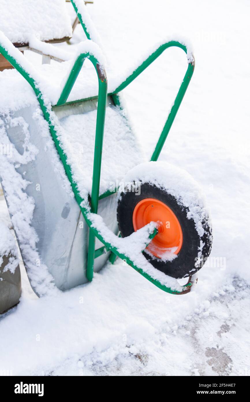 Metal garden wheelbarrow in the snow in winter Stock Photo - Alamy