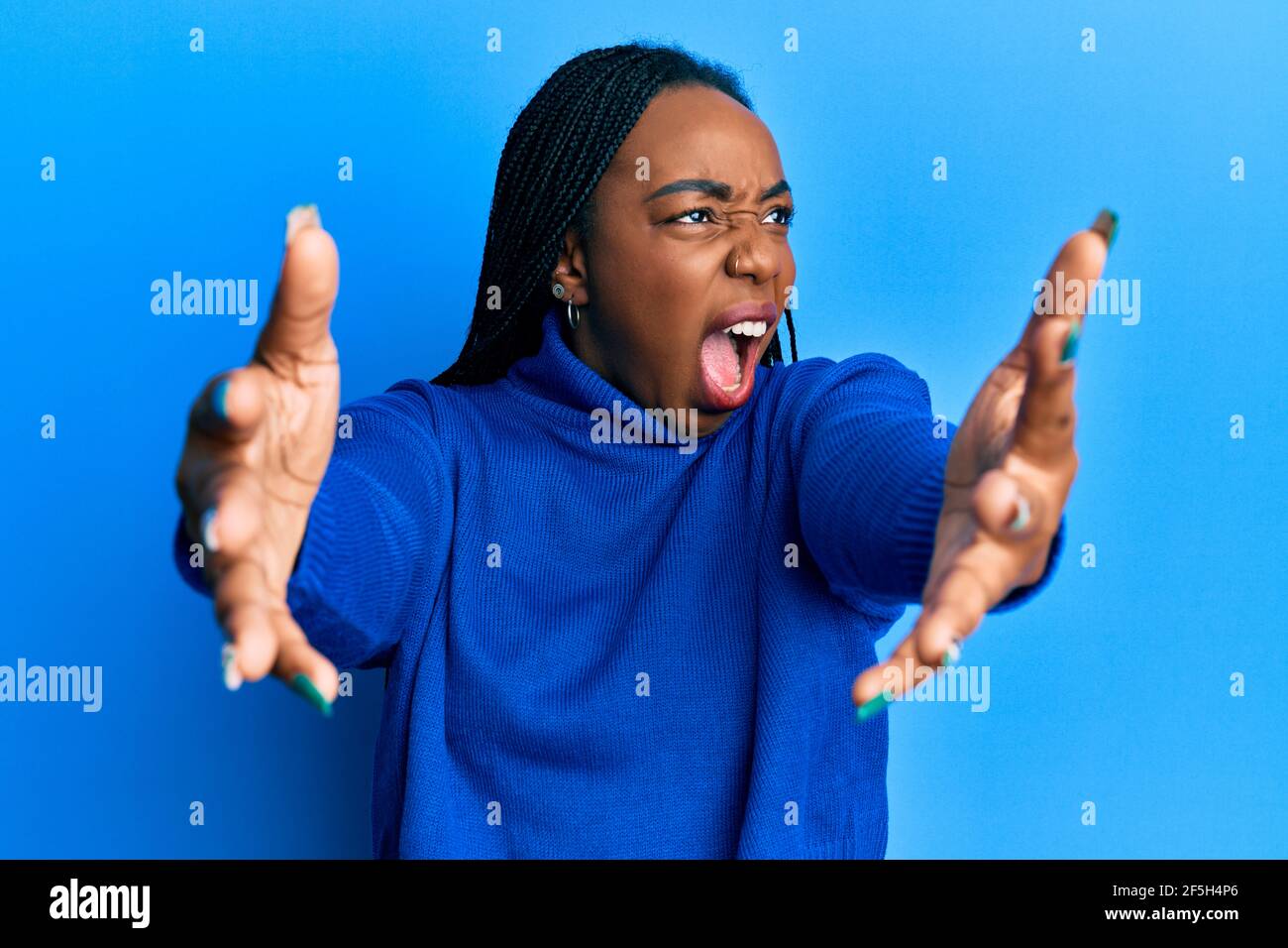 Young african american woman with arms stretched hug gesture angry and ...