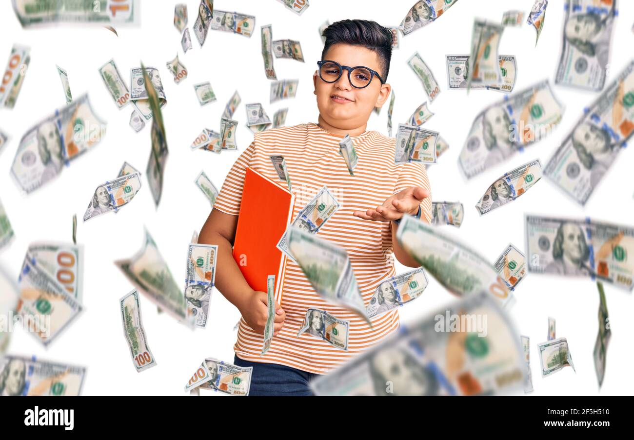 Little boy kid holding book wearing glasses smiling cheerful offering ...