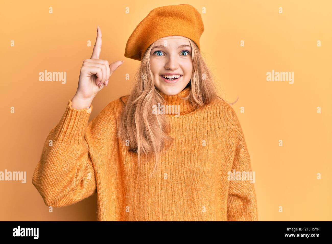 Beautiful young caucasian girl wearing french look with beret pointing ...