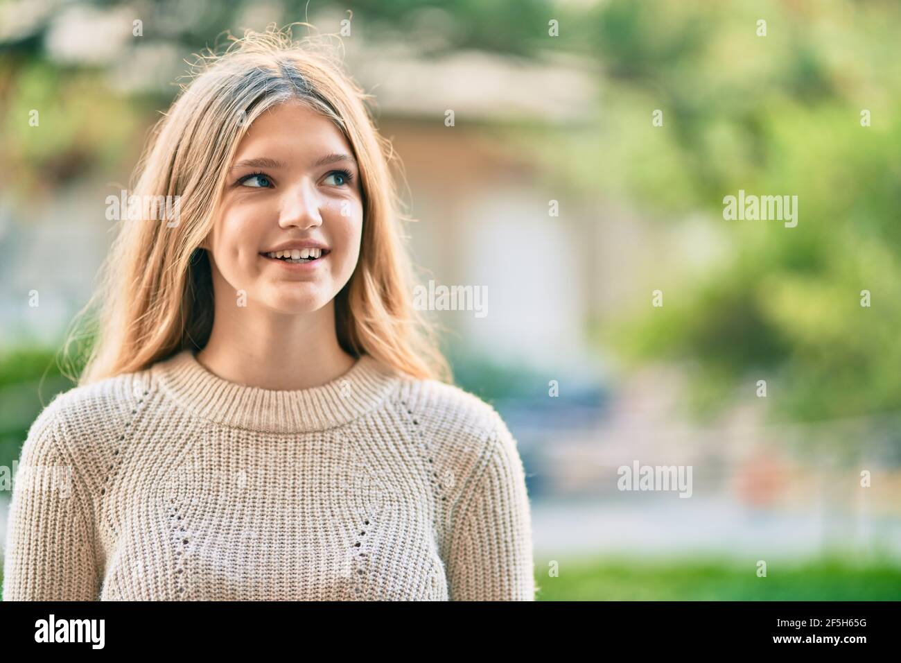 Beautiful caucasian teenager smiling happy standing at the city Stock ...