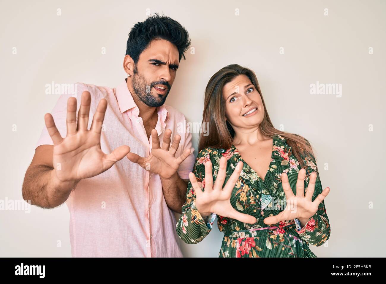 Beautiful young couple of boyfriend and girlfriend together afraid and ...