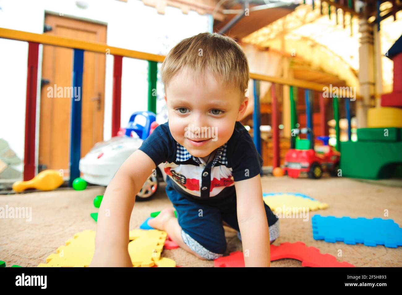 A modern children playground indoor. Boy playing on the playground ...