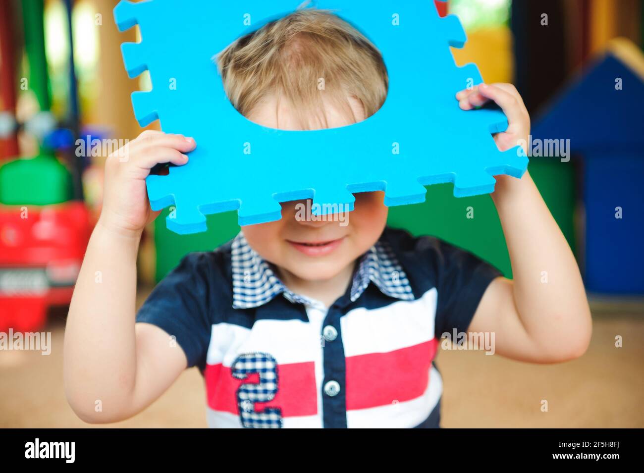 A modern children playground indoor. Boy playing on the playground ...