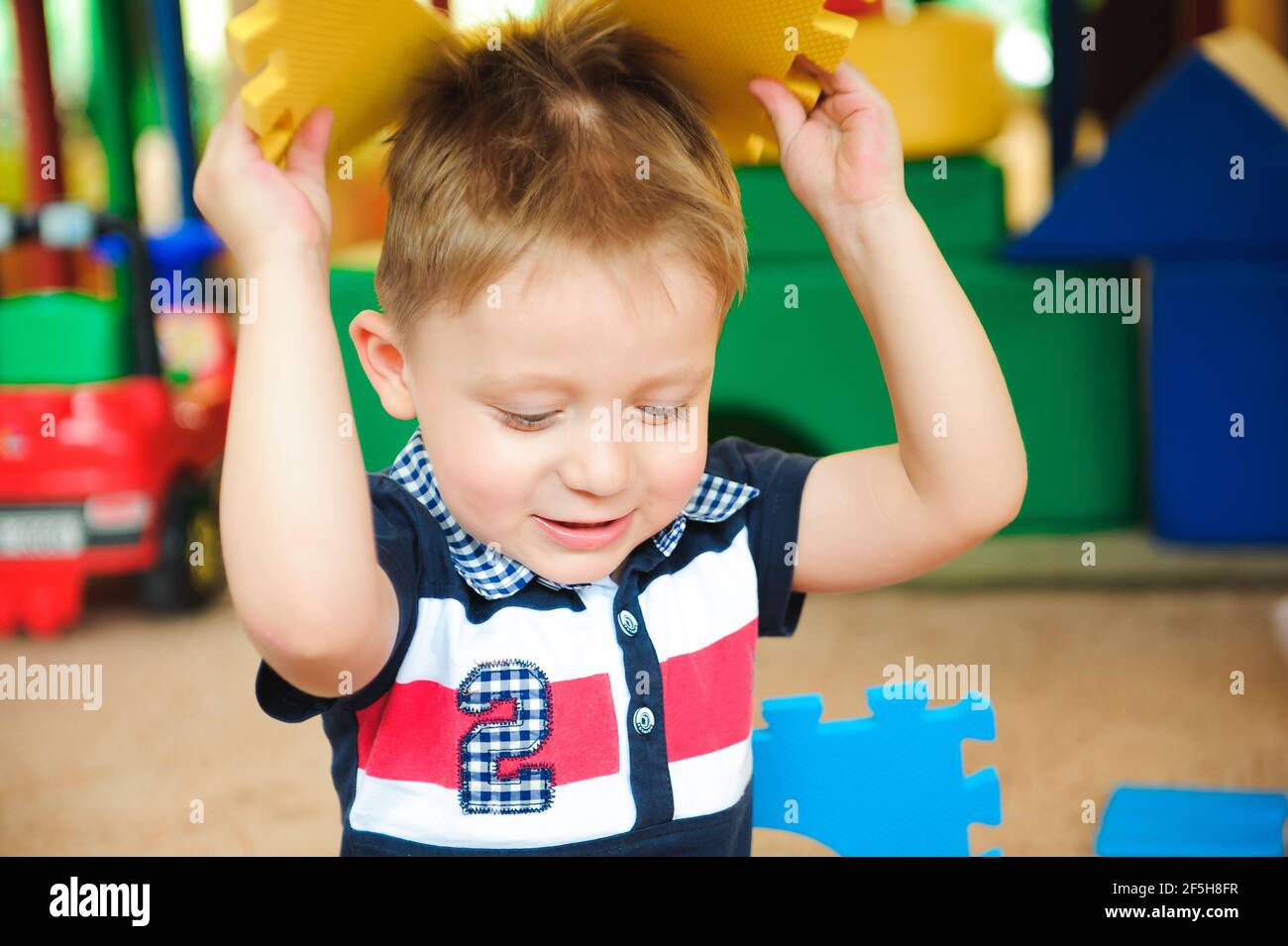 A modern children playground indoor. Boy playing on the playground ...