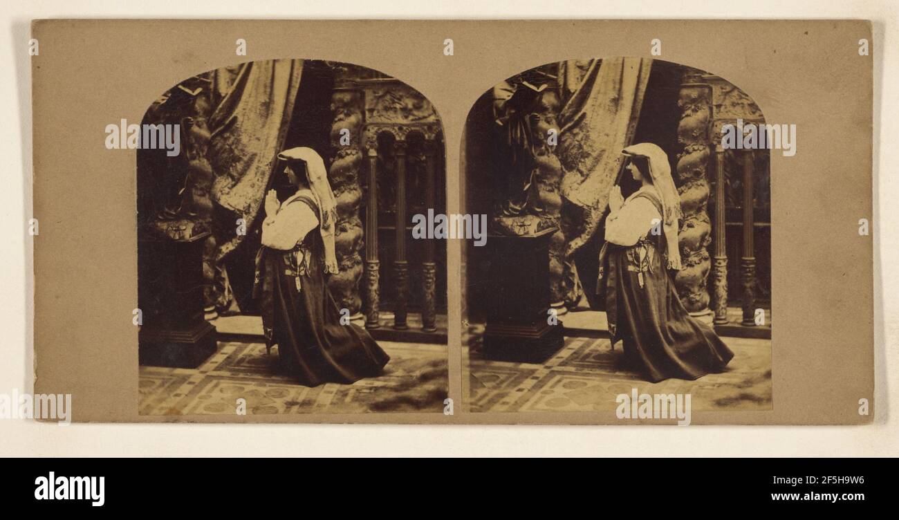 Pious woman with hands in prayer-like position kneeling in profile ...