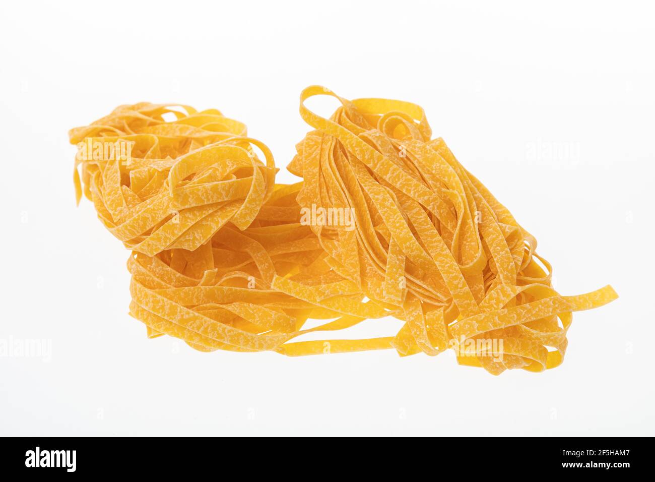 Handmade uncooked and raw egg tagliatelle isolated on white background ...