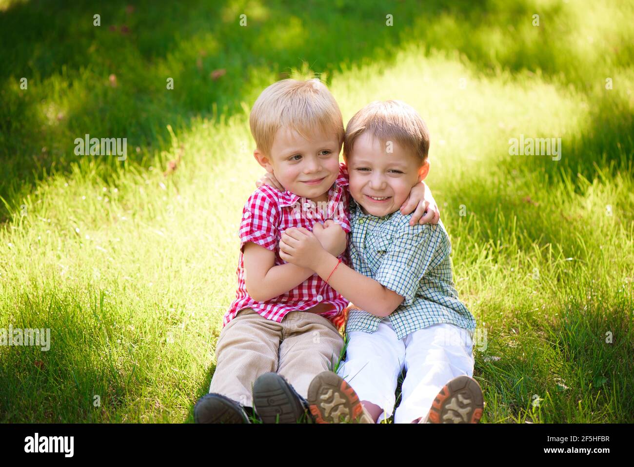 Portrait of two boys embracing and laughing outdoors Stock Photo - Alamy