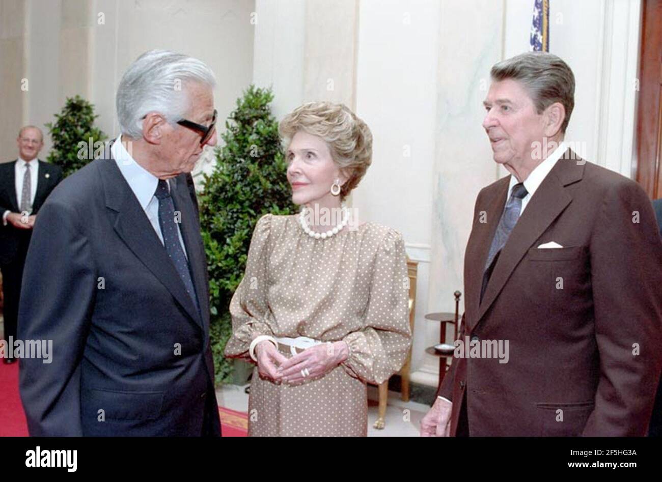 Reagan and Lew Wasserman standing in Cross Hall during Reception and ...