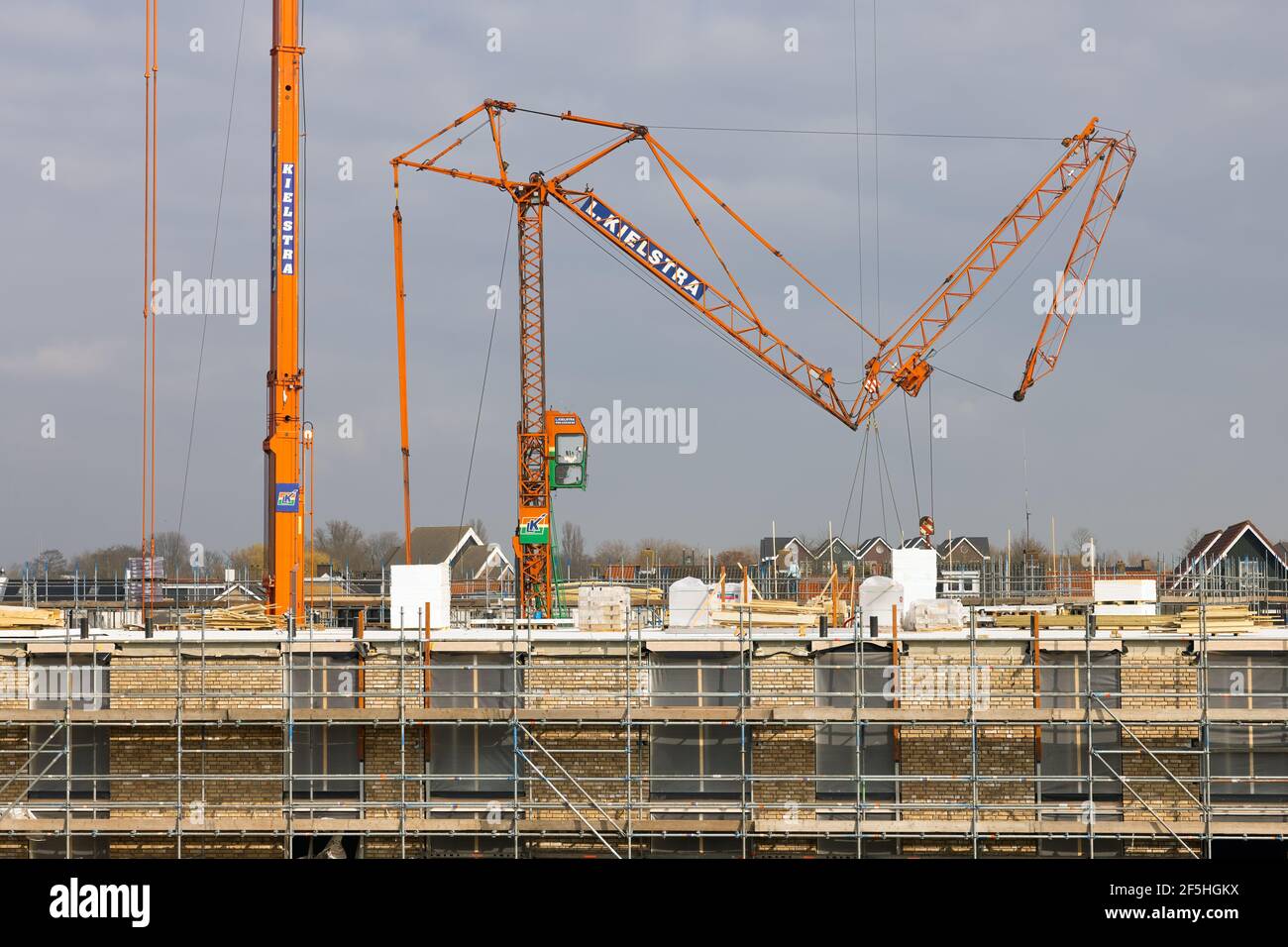 Mobile tower cranes raising at Dutch construction site apartment ...