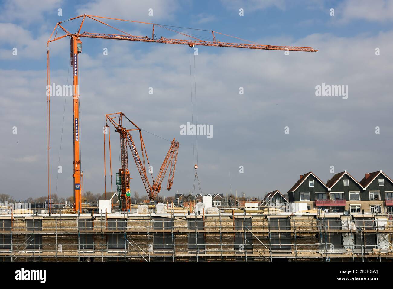 Mobile tower cranes raising at Dutch construction site apartment ...