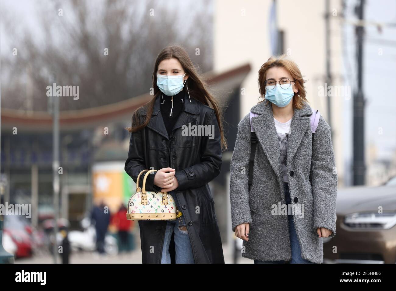 Youong women wearing face masks are seen in Warsaw, Poland on March 26 ...