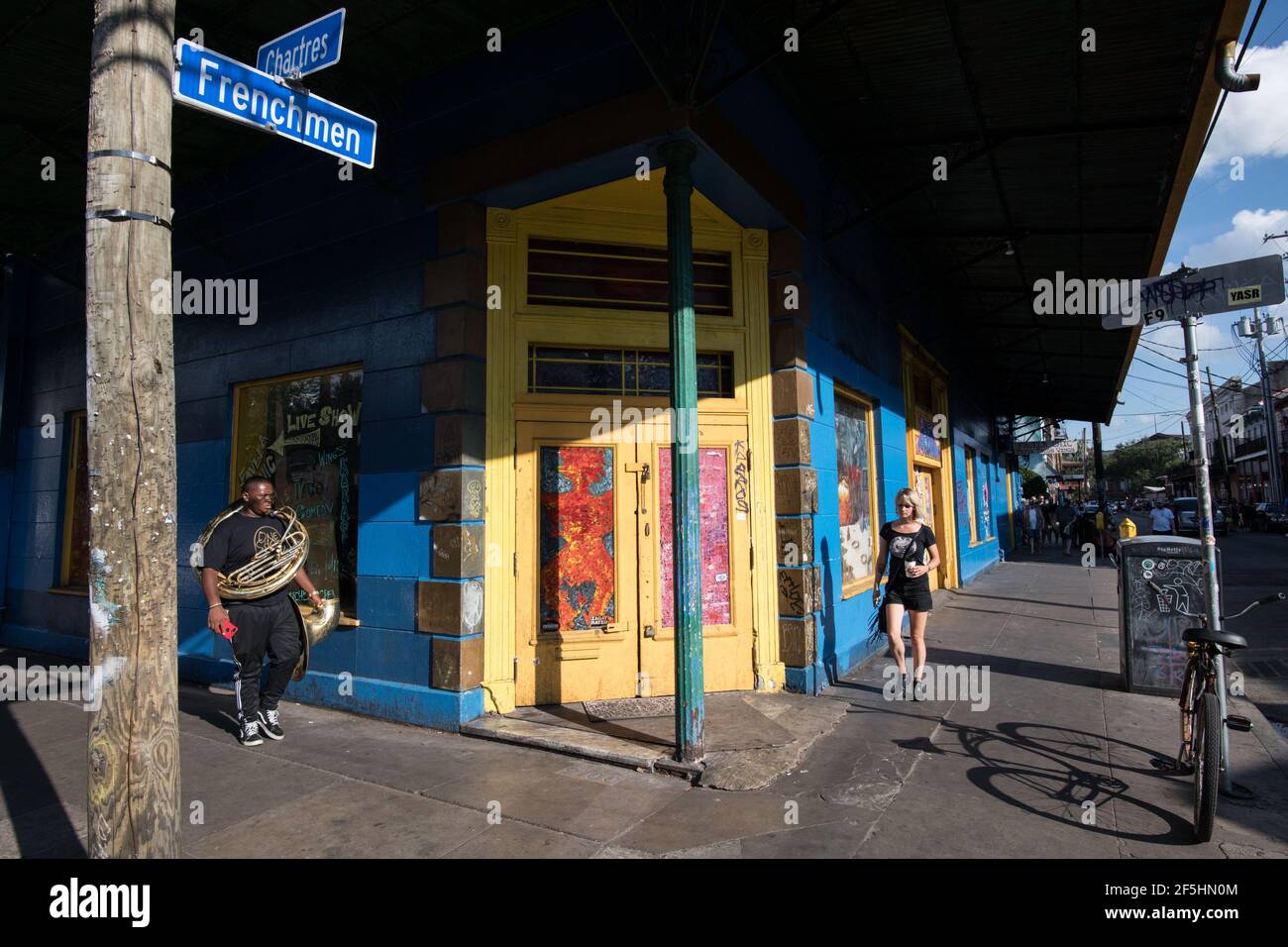 People stroll past the colorful, graffiti-adorned buildings on the ...
