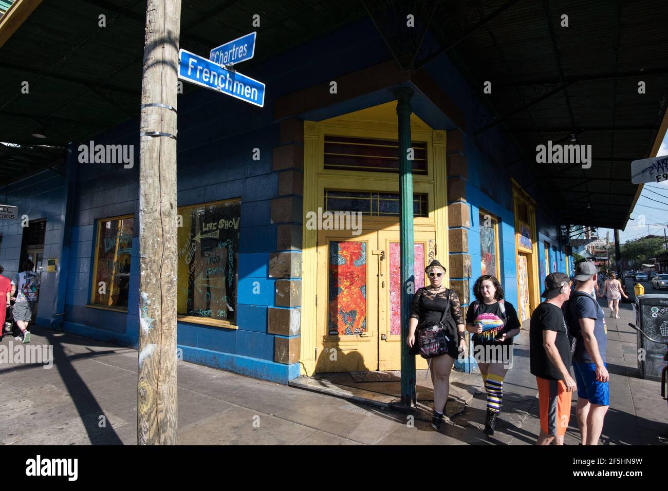 People stroll past the colorful, graffiti-adorned buildings on the ...