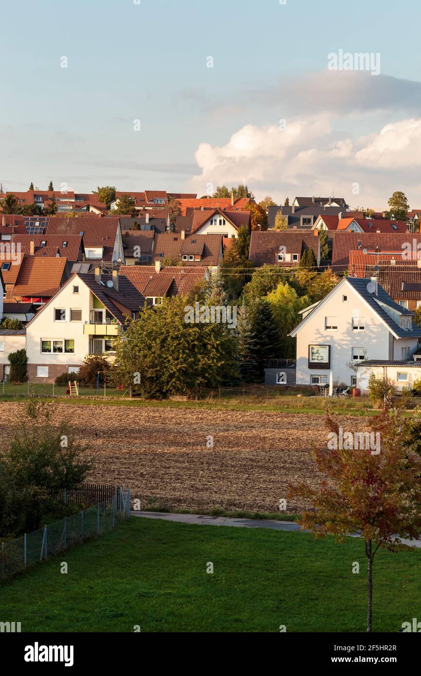 Vertical wide daytime view over an agricultural field and houses in the ...