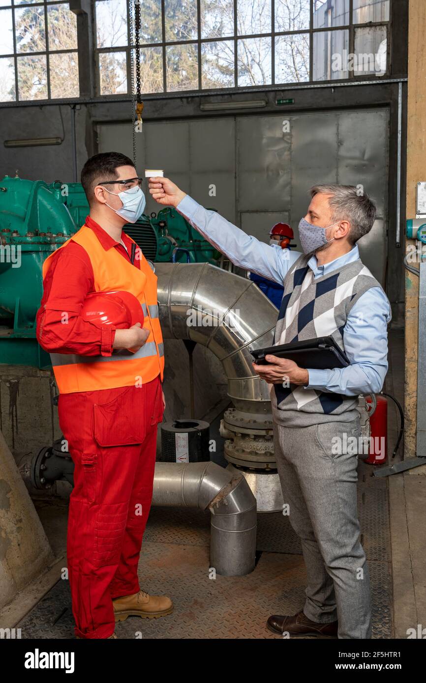 Man Use Infrared Forehead Thermometer at Workplace During a COVID-19 ...