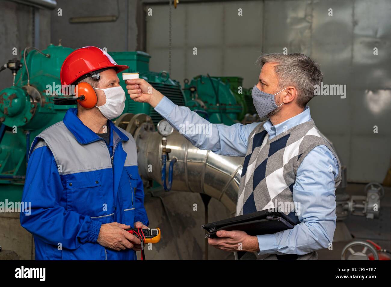 Man Use Infrared Forehead Thermometer at Workplace During a COVID-19 ...